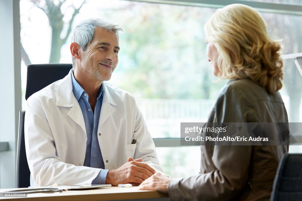 Doctor Consulting Patient In Clinic High-Res Stock Photo - Getty Images Doctor Consulting Patient In Clinic High-Res Stock Photo - Getty Images