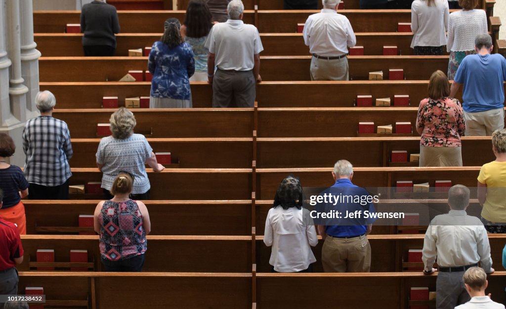 Parishioners Worship During A Mass To Celebrate The Assumption Of The