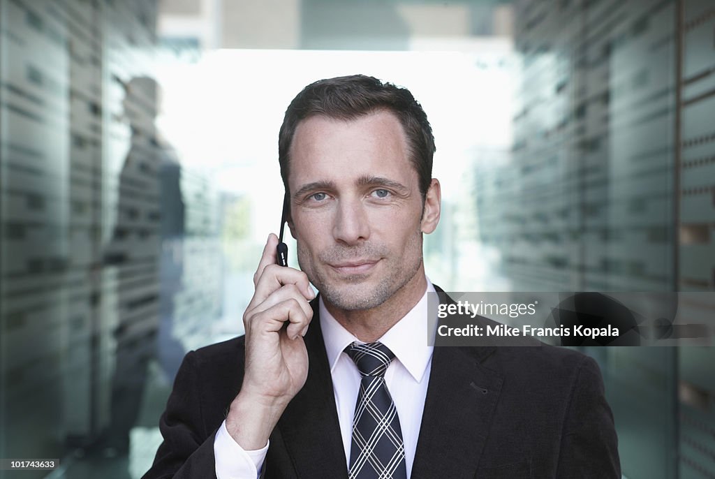 Germany Cologne Businessman Standing In Corridor Using Mobile Phone ... Germany Cologne Businessman Standing In Corridor Using Mobile Phone ...