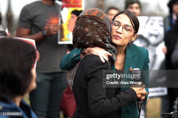 U S Rep Alexandria Ocasio Cortez Hugs Rep Ilhan Omar During A News