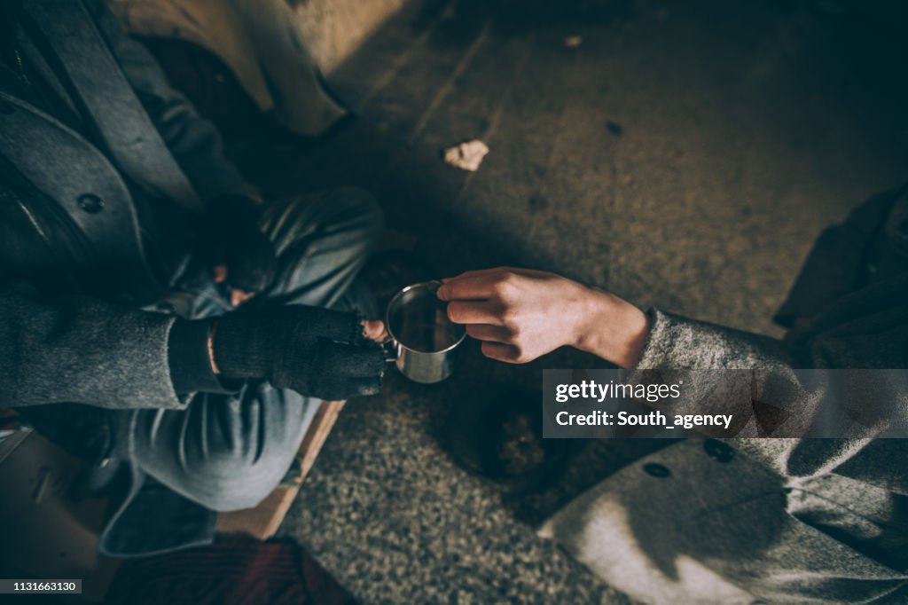 Young Woman Giving Money To Homeless Gay High-Res Stock Photo - Getty ... Young Woman Giving Money To Homeless Gay High-Res Stock Photo - Getty ...