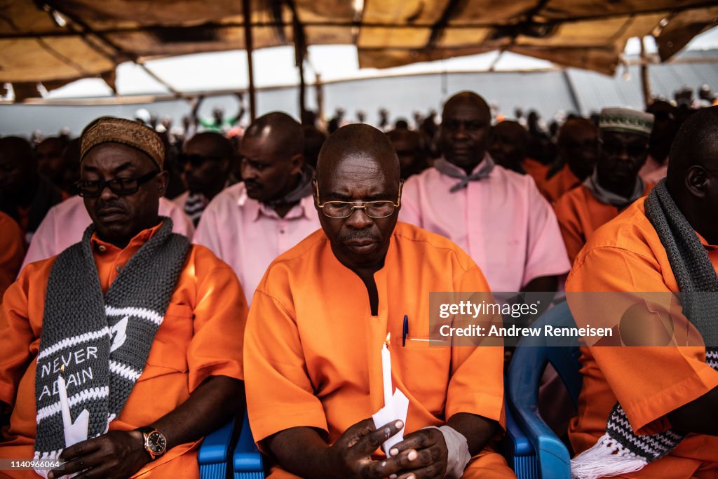 Prisoners Hold Candles During A Genocide Commemoration Ceremony On