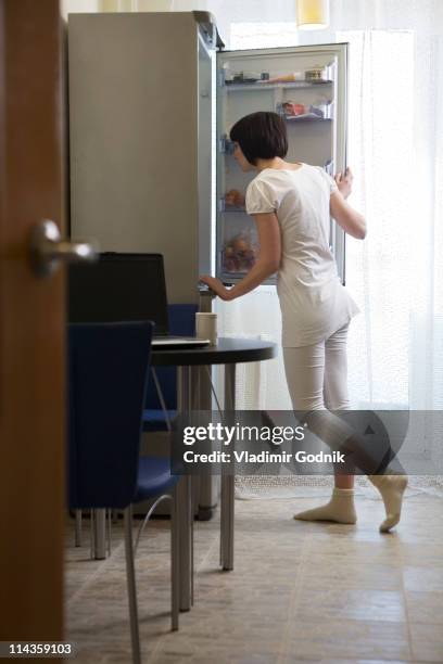 Woman Looking Into Refrigerator Photos And Premium High Res Pictures Getty Images