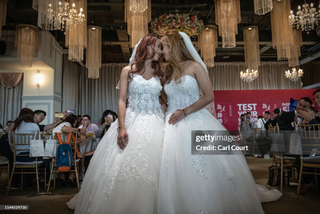 Lesbian Couple Amber And Huan Huan Pose For Photographs During A