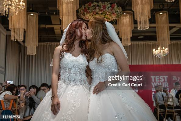 Lesbian Couple Amber And Huan Huan Kiss During A Wedding Event To
