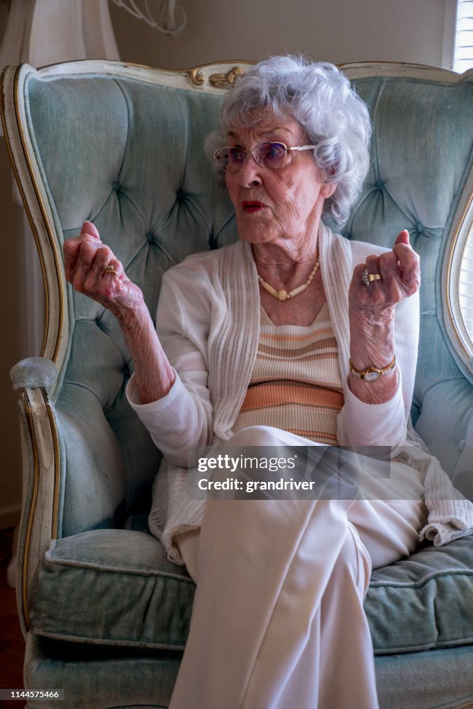 100year Old Woman Having A Cheerful Conversation In Her Home High Res