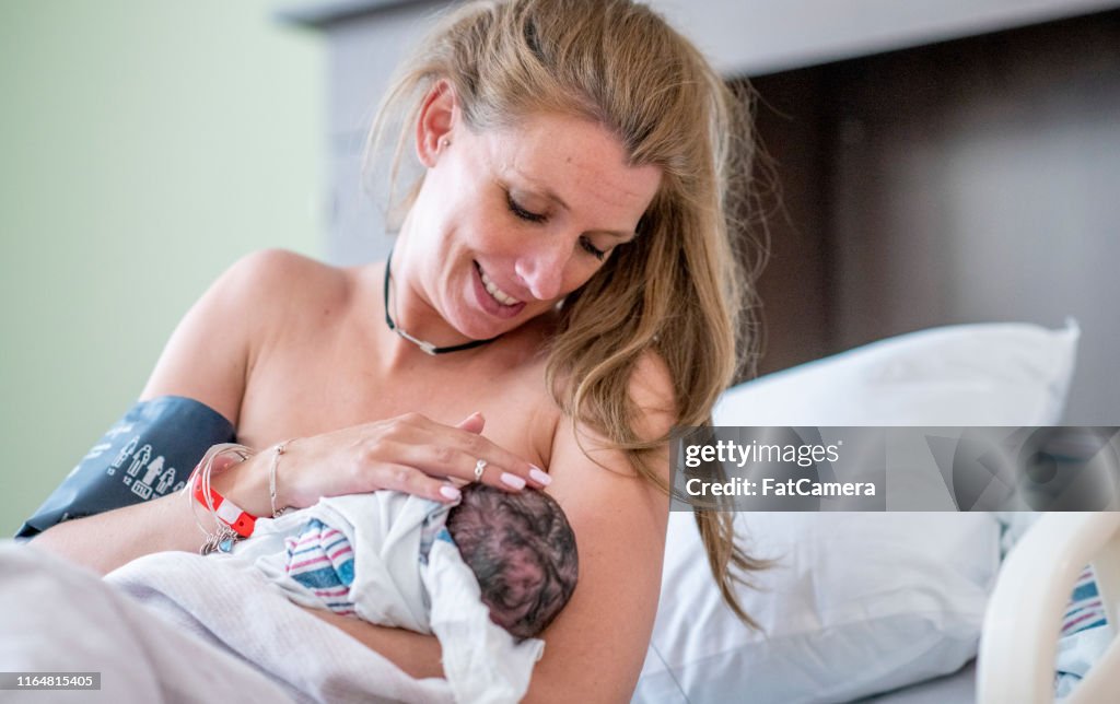 Young Mother Nurses Her Baby High-Res Stock Photo - Getty Images Young Mother Nurses Her Baby High-Res Stock Photo - Getty Images