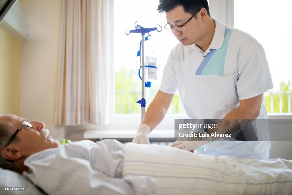 Nurse Attaching Iv Drip On Patients Hand High-Res Stock Photo - Getty ... Nurse Attaching Iv Drip On Patients Hand High-Res Stock Photo - Getty ...