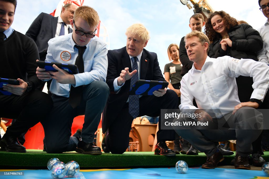 U.K. Prime Minister Boris Johnson takes part in an activity with ... U.K. Prime Minister Boris Johnson takes part in an activity with ...