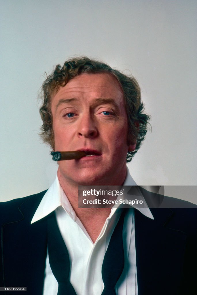 Portrait of English actor Michael Caine, a cigar in his mouth, as he ... Portrait of English actor Michael Caine, a cigar in his mouth, as he ...