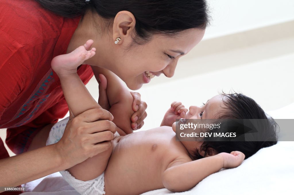 Cheerful Young Mother Holding Baby Boy High-Res Stock Photo - Getty Images Cheerful Young Mother Holding Baby Boy High-Res Stock Photo - Getty Images