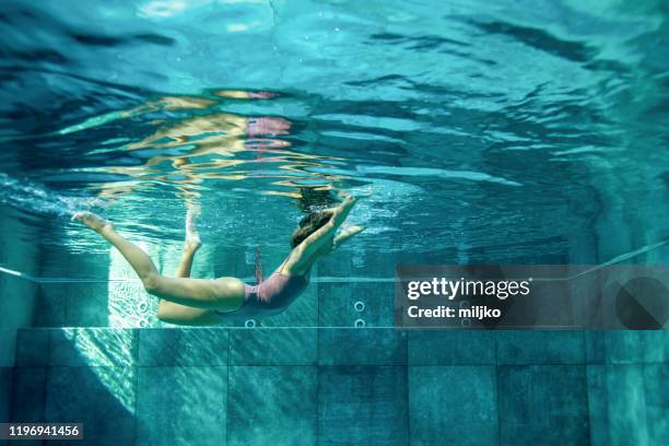 One Piece Swimsuit Underwater Photos And Premium High Res Pictures