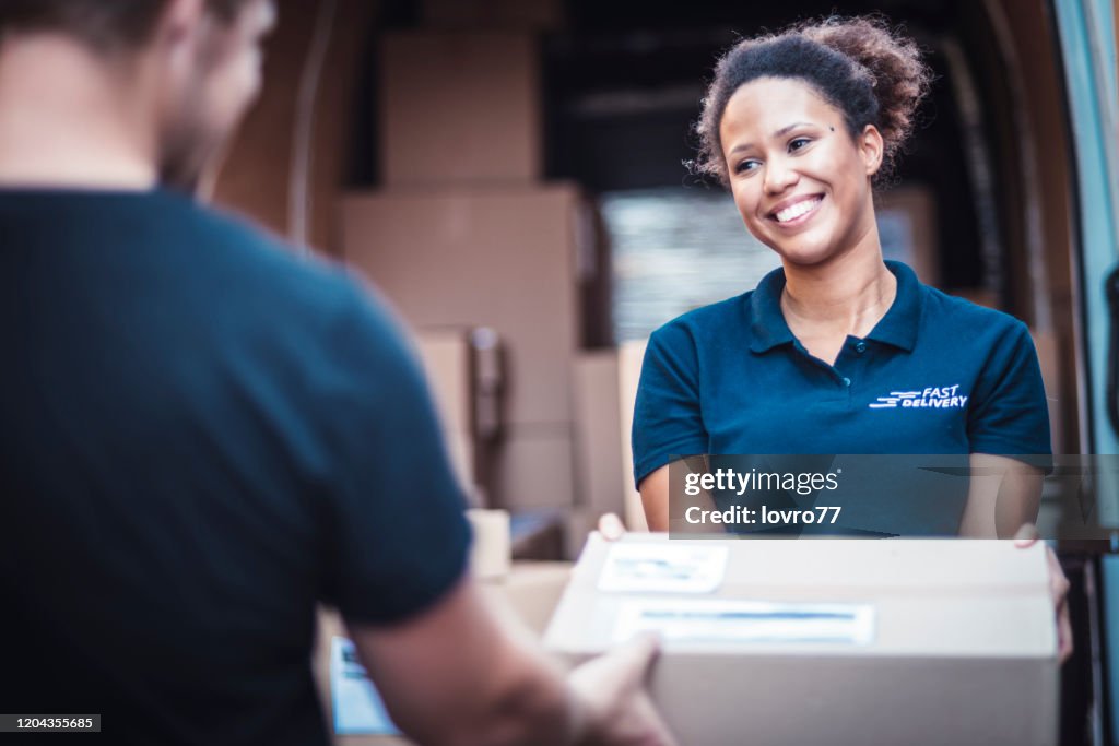 Coworkers Rushing To Load Packages In A Delivery Van High-Res Stock ... Coworkers Rushing To Load Packages In A Delivery Van High-Res Stock ...
