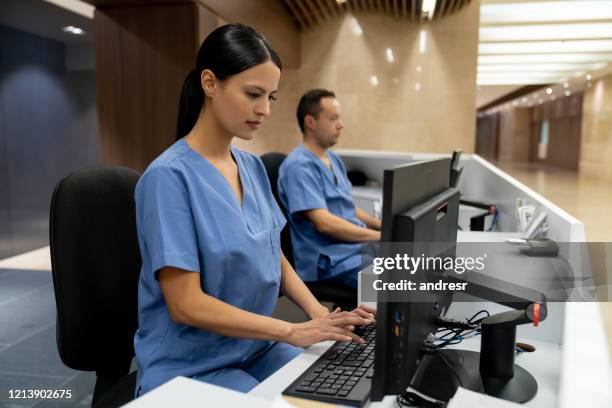 Happy Receptionist Working At A Hospital High-res Stock Photo - Getty