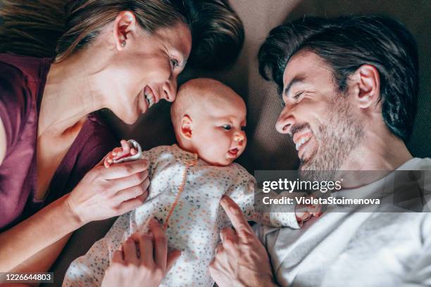 60 Overhead View Smiling Mother And Daughter Hugging On Bed Stock