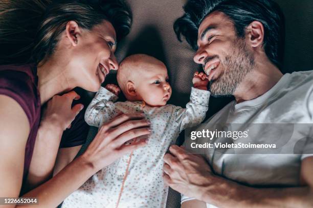 60 Overhead View Smiling Mother And Daughter Hugging On Bed Stock