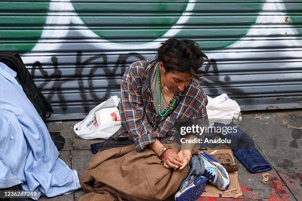 A Homeless Woman Is Seen On Streets Of The Tenderloin District In San