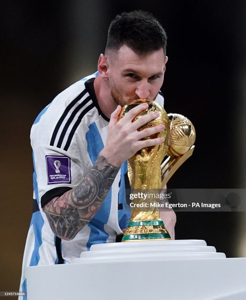 Argentinas Lionel Messi Kisses The Fifa World Cup Trophy After Being