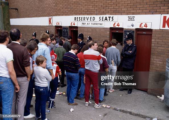 Police Watch As Fans Patiently Wait To Enter The Ground Via The News