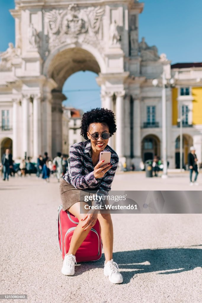 Woman Taking Selfie With Smart Phone While Sitting Against Praco Do