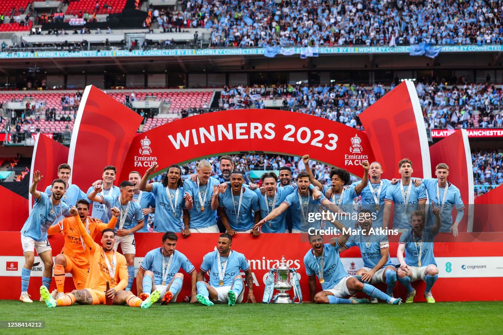 Manchester City Players Celebrate With The Trophy During The Emirates