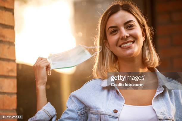 Happy Woman Taking Off Mask Photos And Premium High Res Pictures