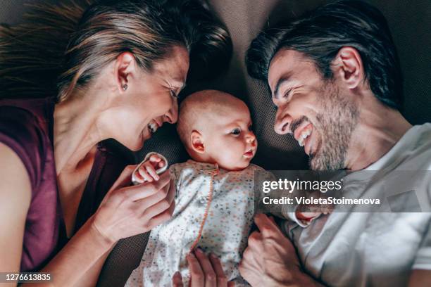 60 Overhead View Smiling Mother And Daughter Hugging On Bed Stock