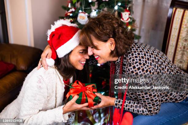 Mother Daughter Christmas Hug Photos And Premium High Res Pictures