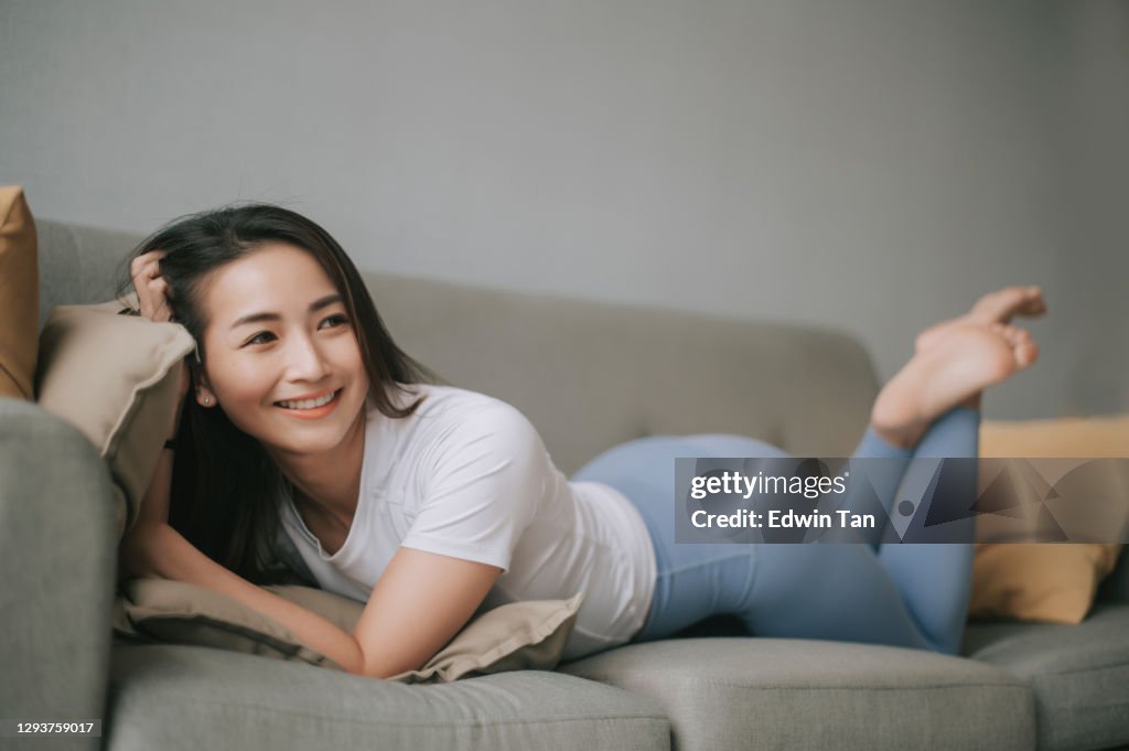Asian Chinese Beautiful Woman Lying Down On Sofa Relax Taking A Break