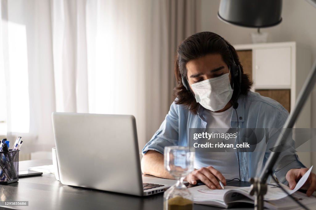Young Man Studying And Working On Laptop At Home High-Res Stock Photo ... Young Man Studying And Working On Laptop At Home High-Res Stock Photo ...