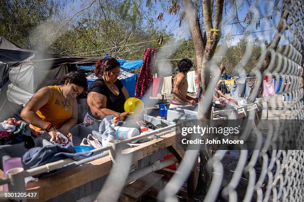 Central American Immigrants Wash Clothing Inside A Camp For Asylum