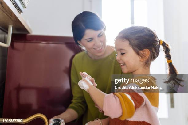 Mother And Daughter Washing Dishes Photos And Premium High Res Pictures