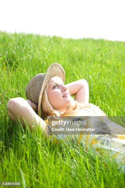 Blonde Girl Lying On Grass Sun Photos And Premium High Res Pictures