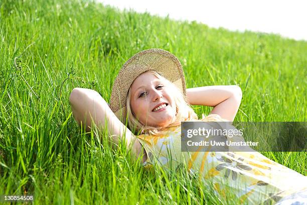 Blonde Girl Lying On Grass Sun Photos And Premium High Res Pictures