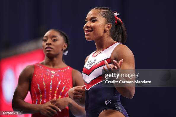 Simone Biles And Jordan Chiles Look On During Warm Ups Prior To The