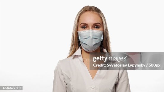 Portrait Of Woman Wearing Surgical Mask Against White Background High