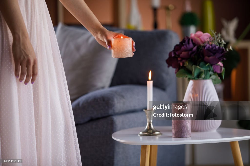 Young Woman Setting Up Candles In Her Home High-Res Stock Photo - Getty ... Young Woman Setting Up Candles In Her Home High-Res Stock Photo - Getty ...