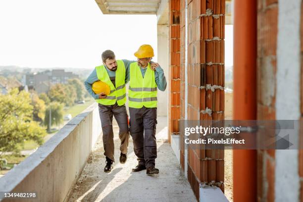 Manual Worker Helping Injured Co-worker After Accident at Construction ...