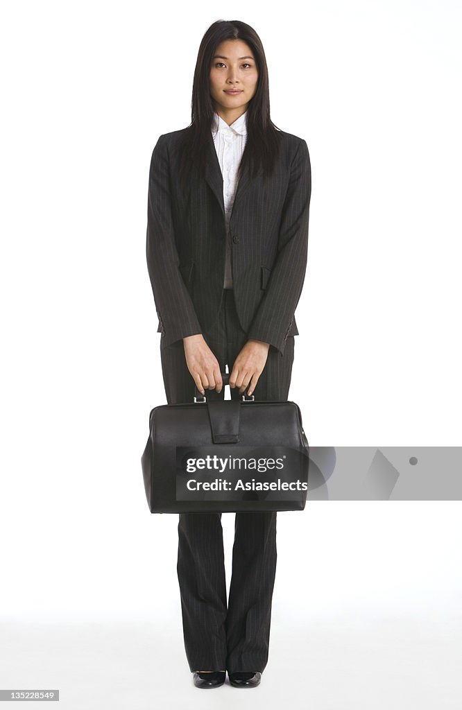 Portrait Of A Businesswoman Holding A Briefcase And Standing High-Res ... Portrait Of A Businesswoman Holding A Briefcase And Standing High-Res ...