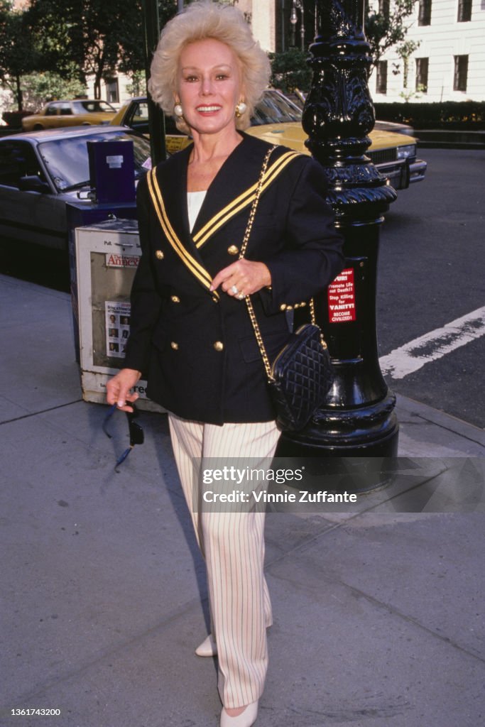 Hungarian American Actress And Socialite Eva Gabor Wearing A News
