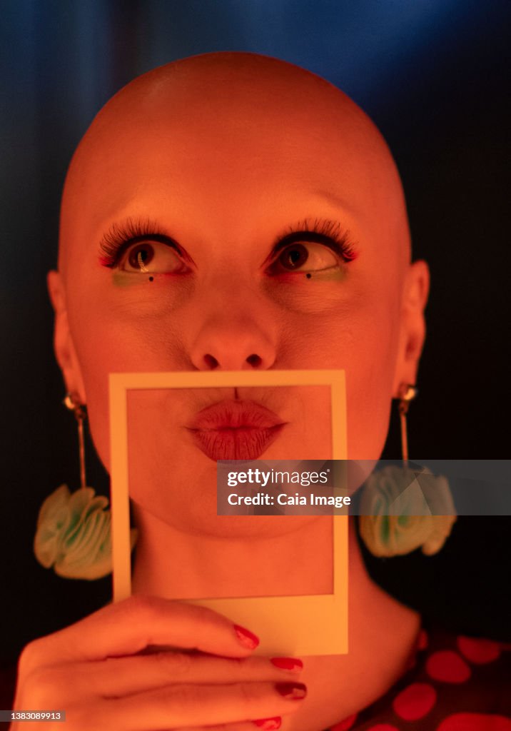 Portrait Stylish Woman With Shaved Head Holding Polaroid High Res Stock
