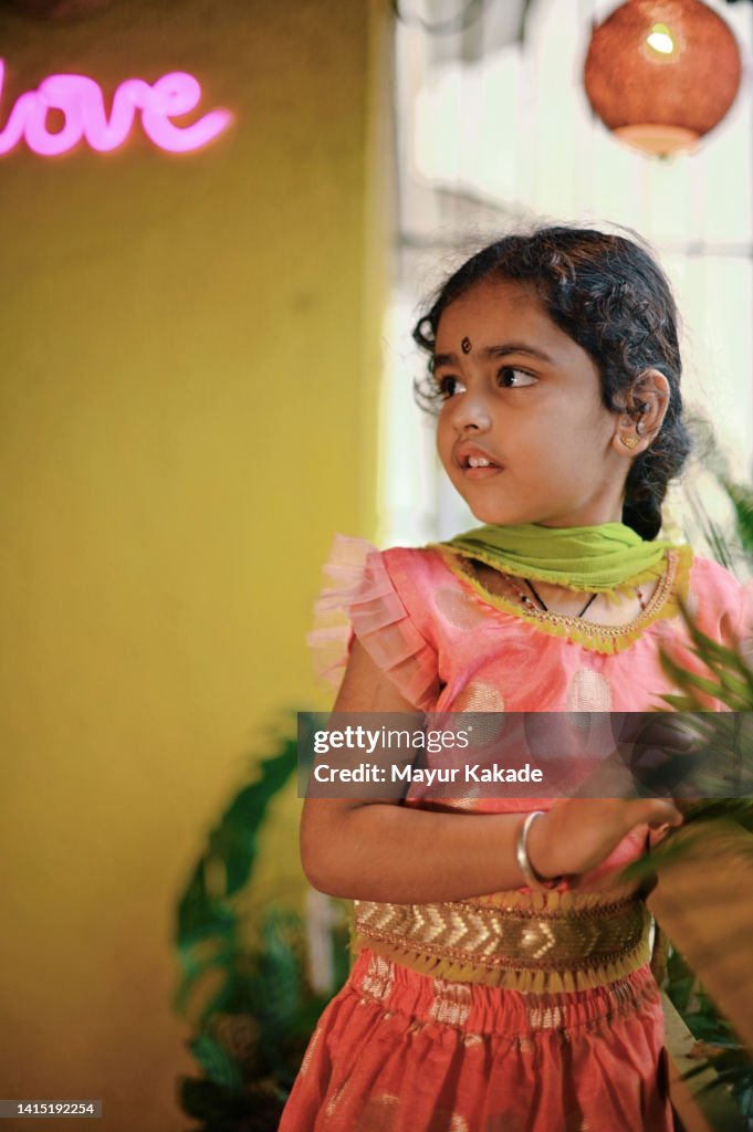 Portrait Of Cute Indian Girl Wearing Traditional Clothes Standing In