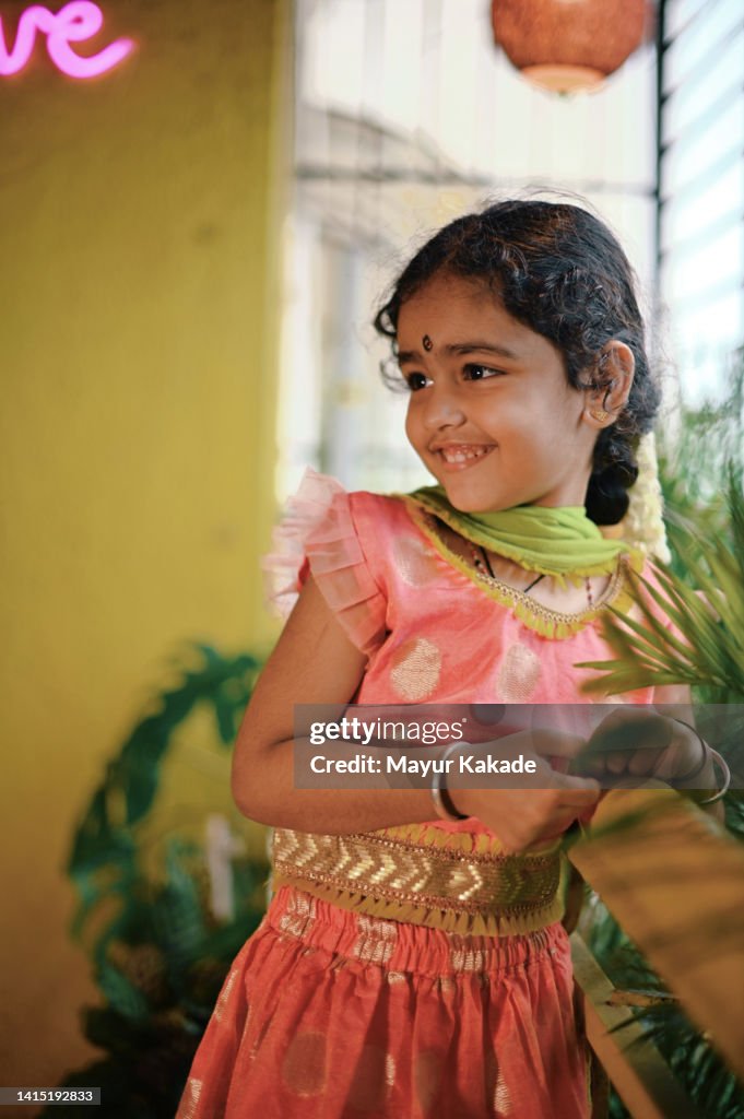 Portrait Of Cute Indian Girl Wearing Traditional Clothes Standing In