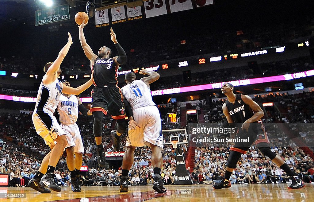 Miami Heat's Dwyane Wade goes up between several Orlando Magic... News ... Miami Heat's Dwyane Wade goes up between several Orlando Magic... News ...