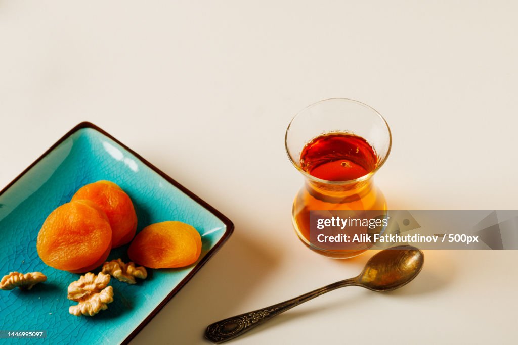 Black Traditional Turkish Tea In A Glass Cup And Dried Fruits On A
