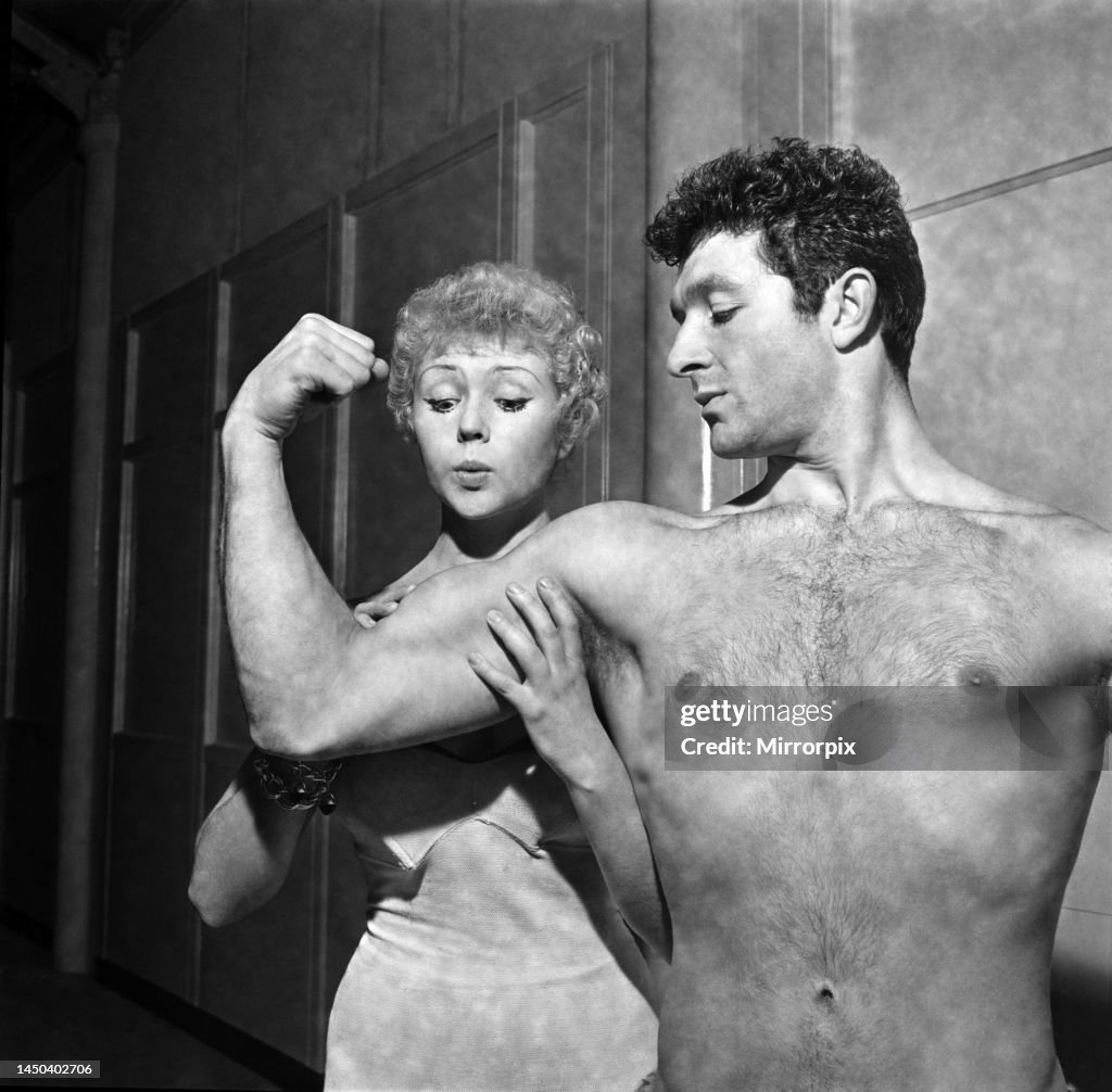 Television Strong Man Arthur Mason Shows Off His Muscles To News