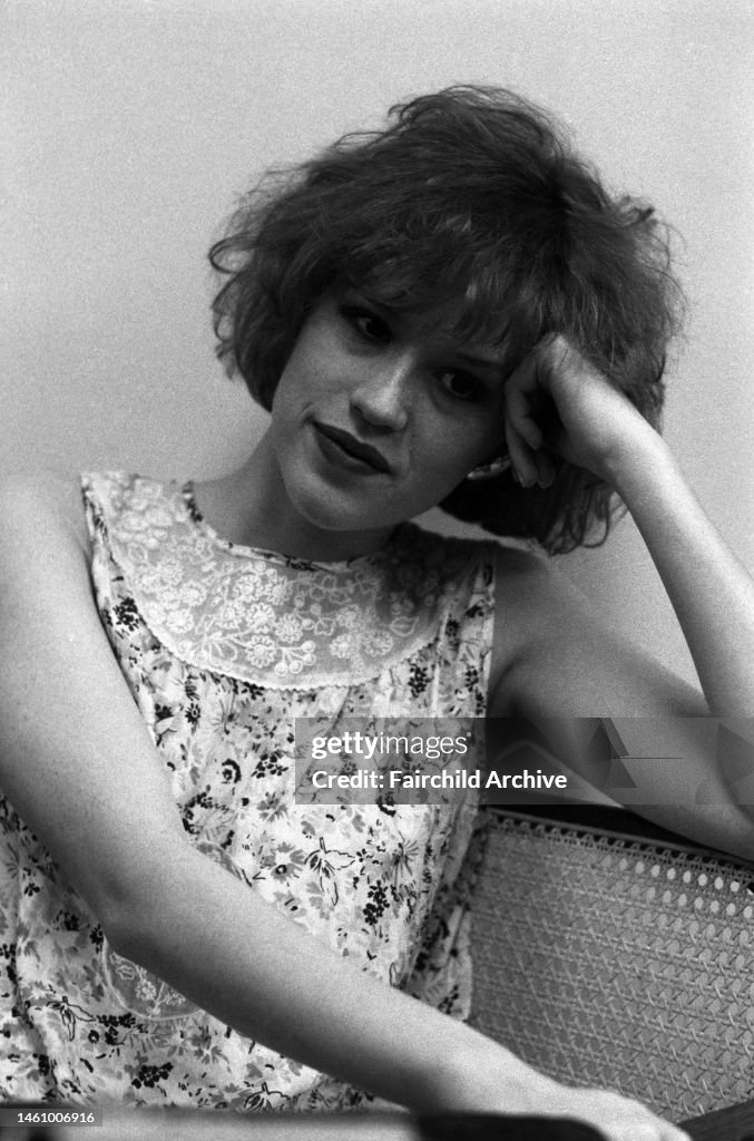Portrait Of Actress Molly Ringwald Seated In A Chair Wearing A Floral