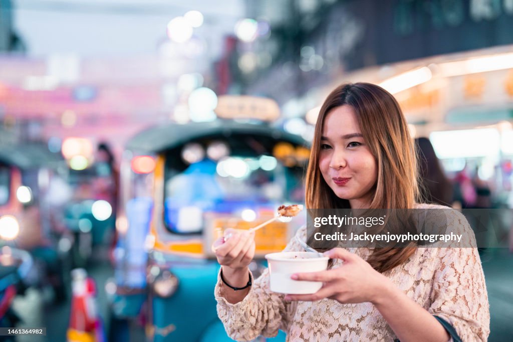 Young Asian Woman Enjoy Street Food On Yaowarat Road Or China Town In Bangkok High Res Stock