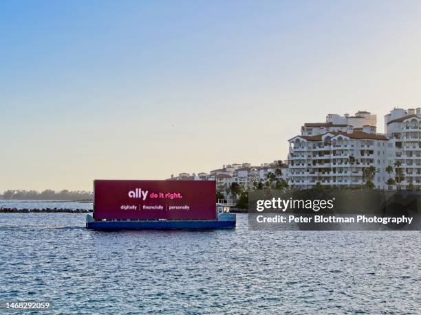A floating digital billboard reenters the port of Miami after ...