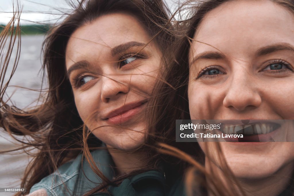 Two Happy Smiling Women Making Selfie On A Windy Day Close Up Of Two